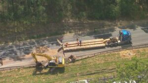 Excavator Crash Shuts Down Major Highway: Overhead Bridge Struck by ...